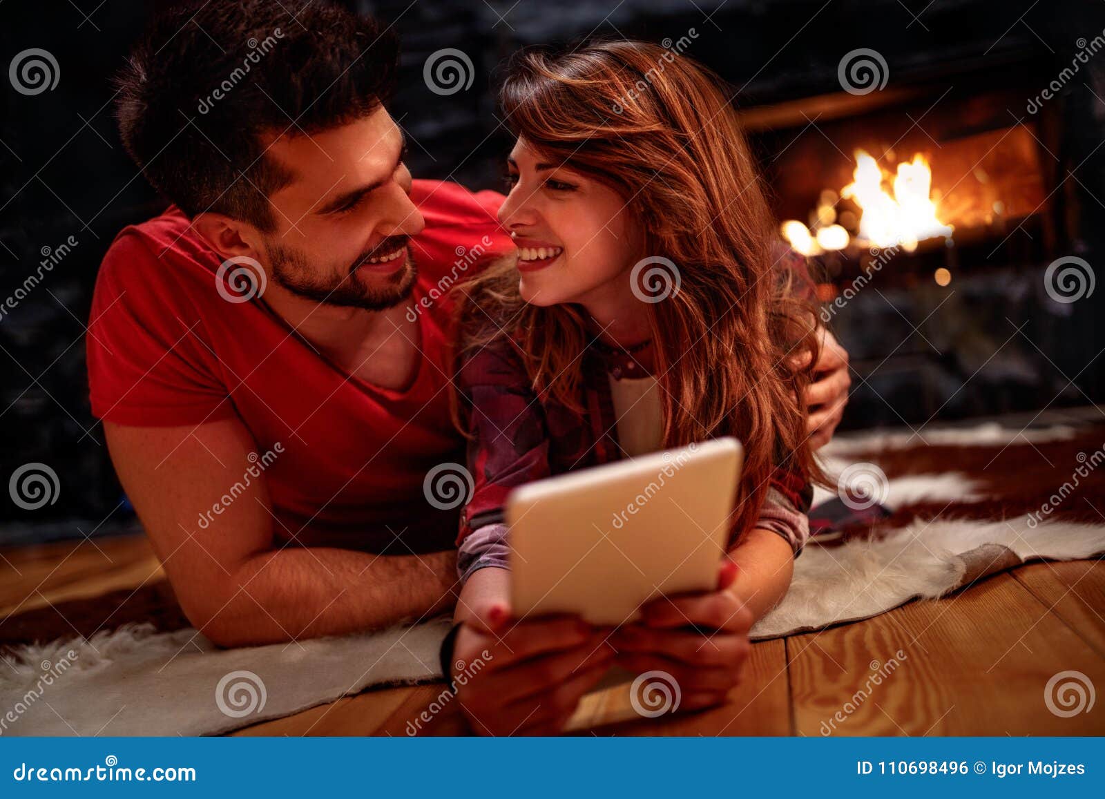 Romantic Couple Laying on Floor and Using Tablet at Home Stock Photo ...