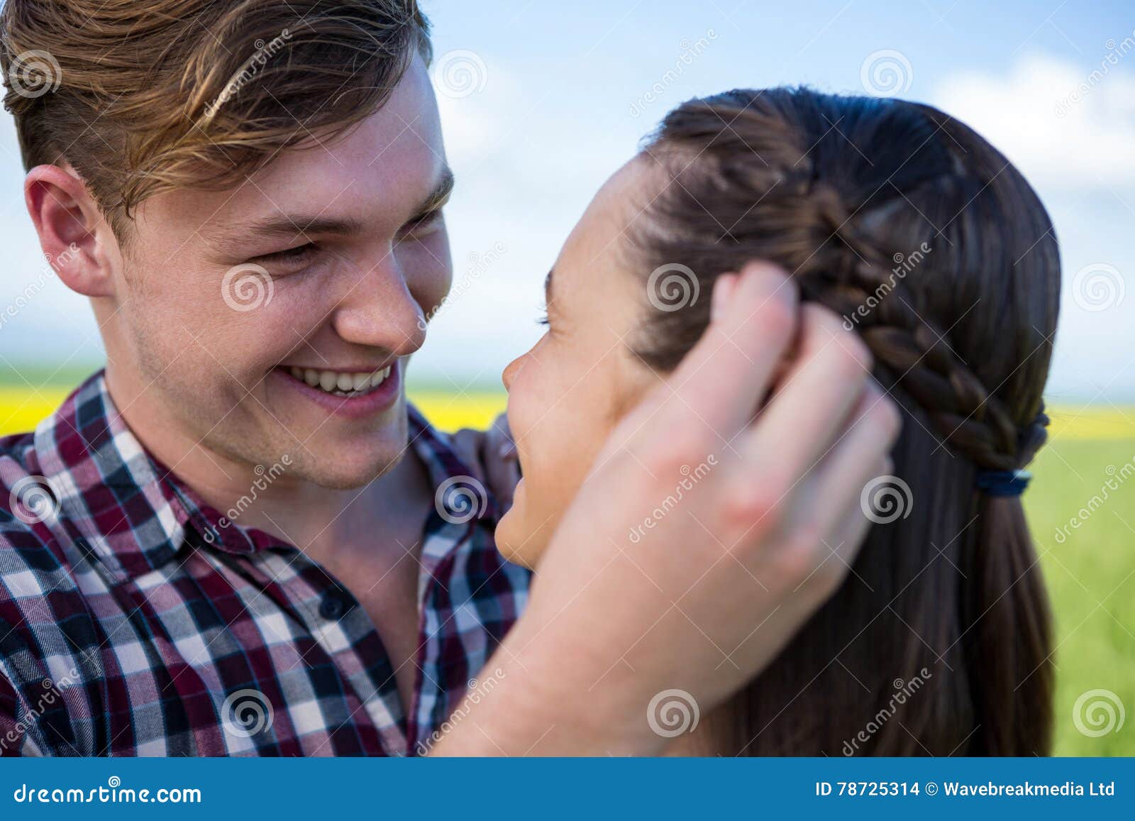 Romantic Couple Looking at Each Other in Field Stock Photo - Image of ...