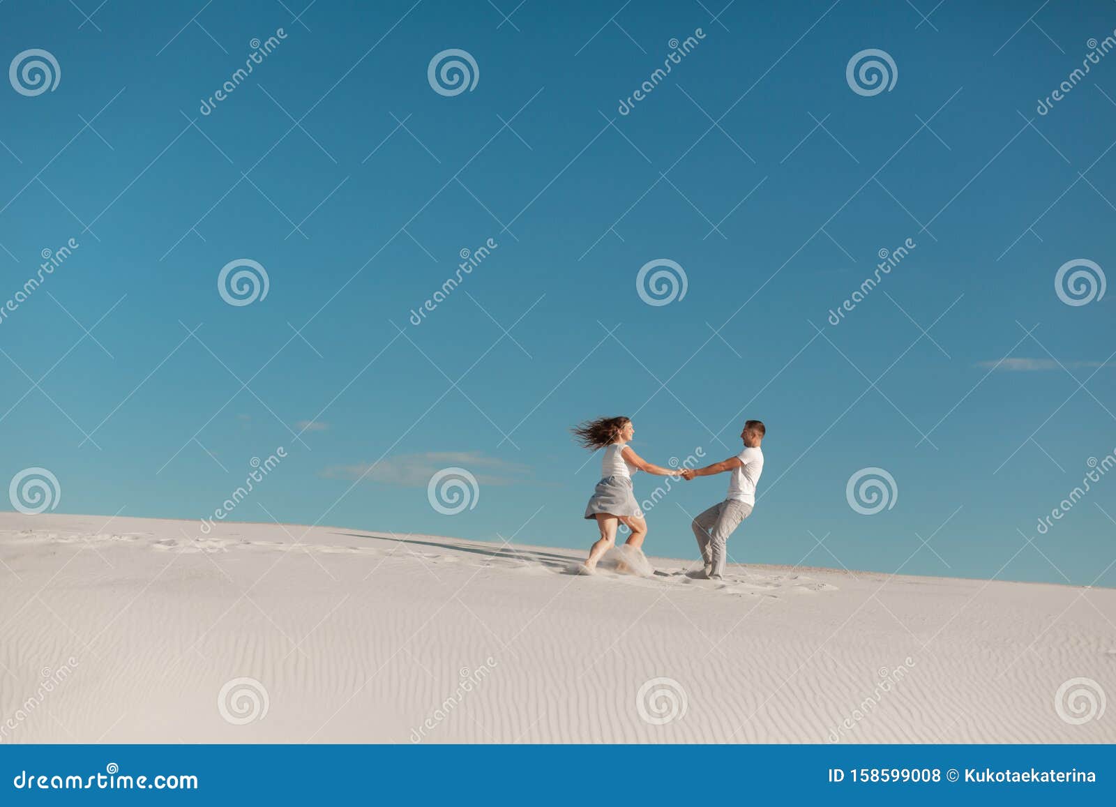 Romantic Couple in Love Running on White Sand in Desert Stock Photo ...