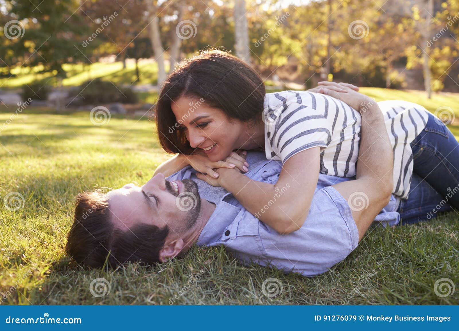 Romantic Couple Lying On Grass In Park Together Stock Image Image Of