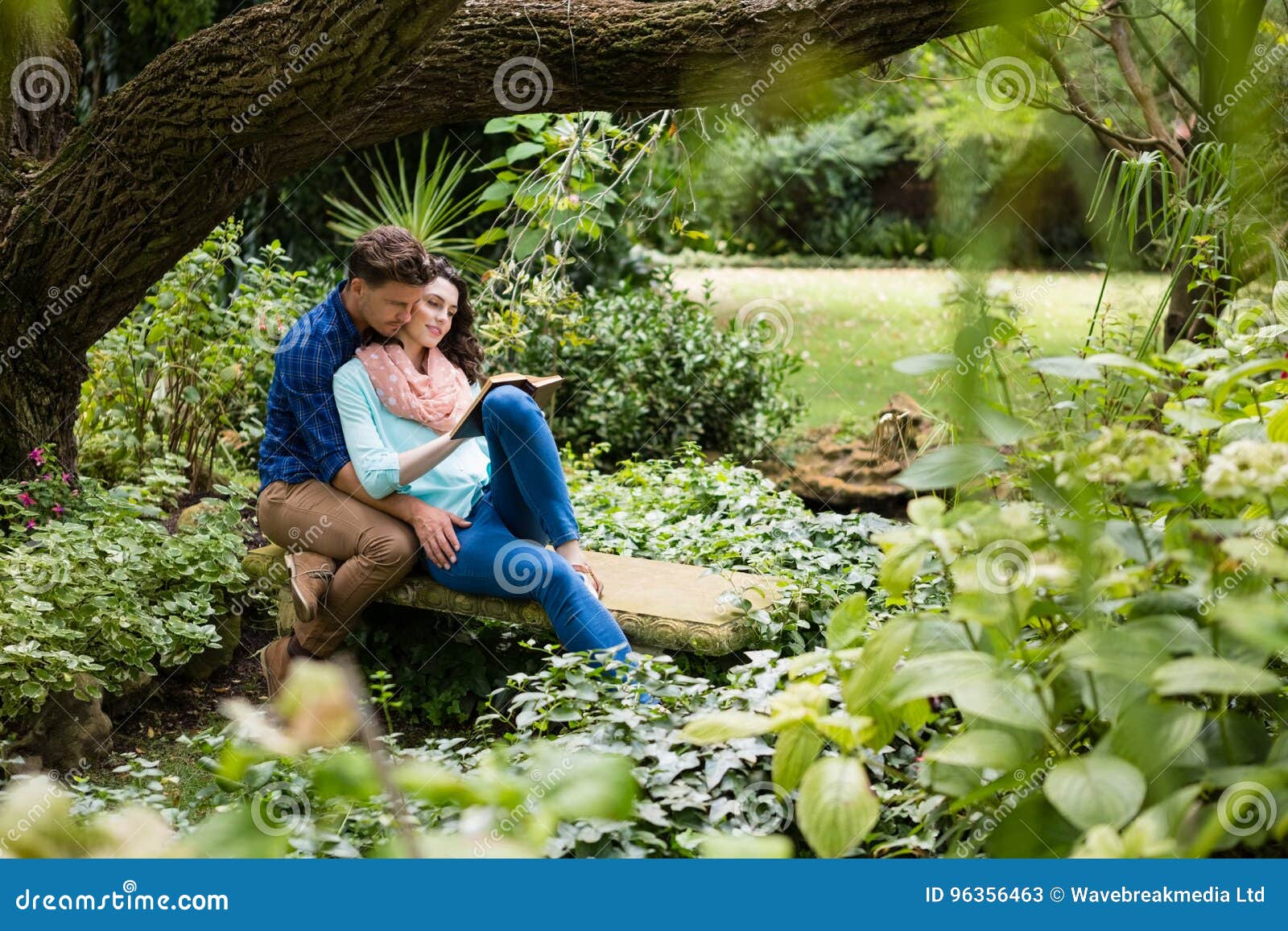 Romantic Couple Reading Book On Bench In Garden Stock Image Image Of