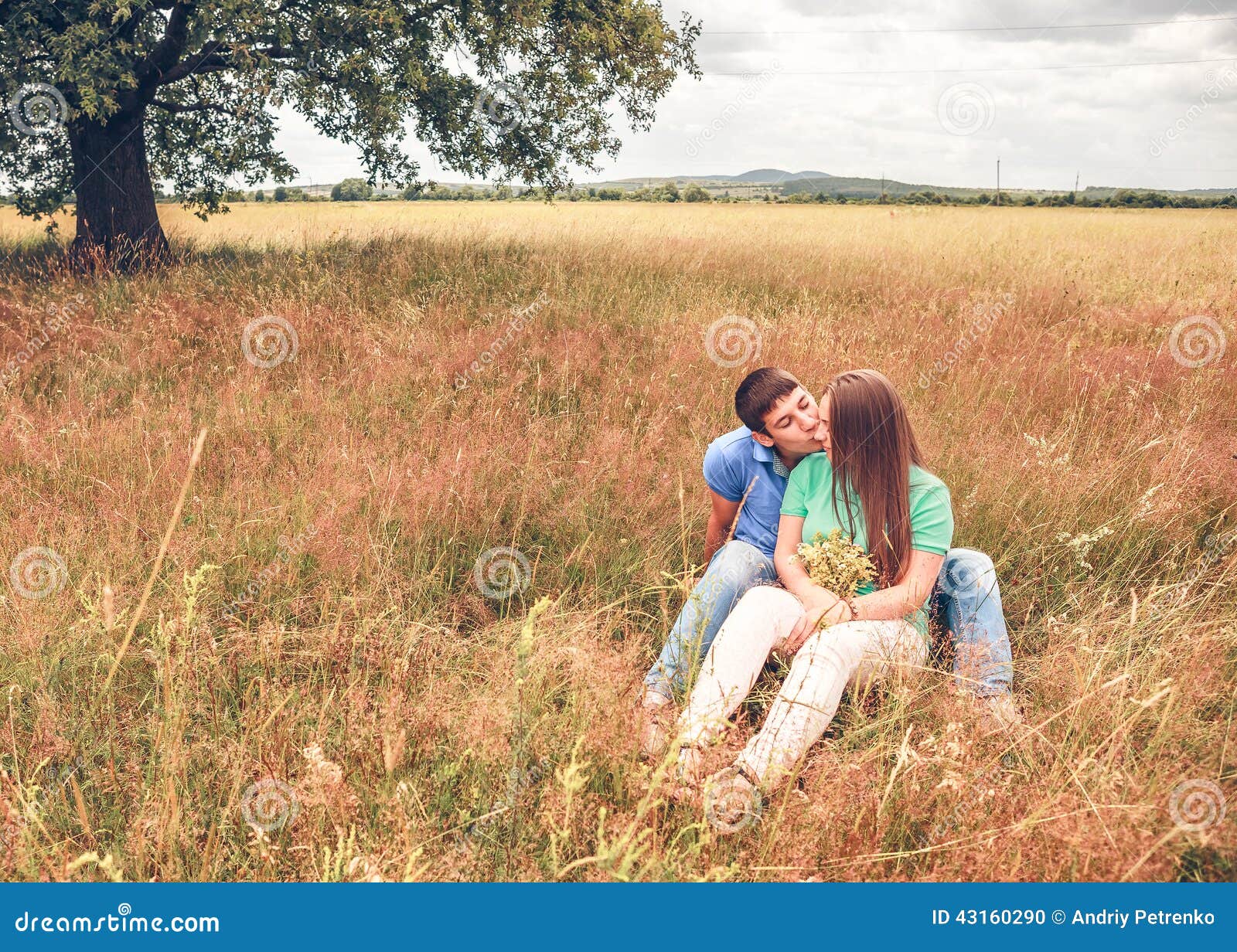 Romantic Couple Relaxing in Field Stock Photo - Image of closed, front ...