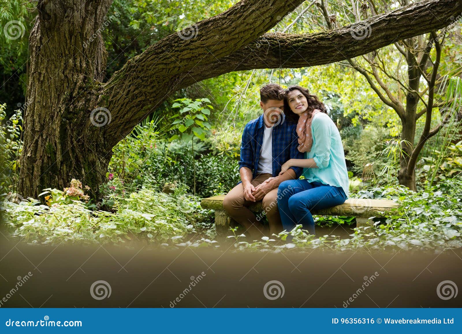 Romantic Couple Sitting on Bench in Garden Stock Photo - Image of ...