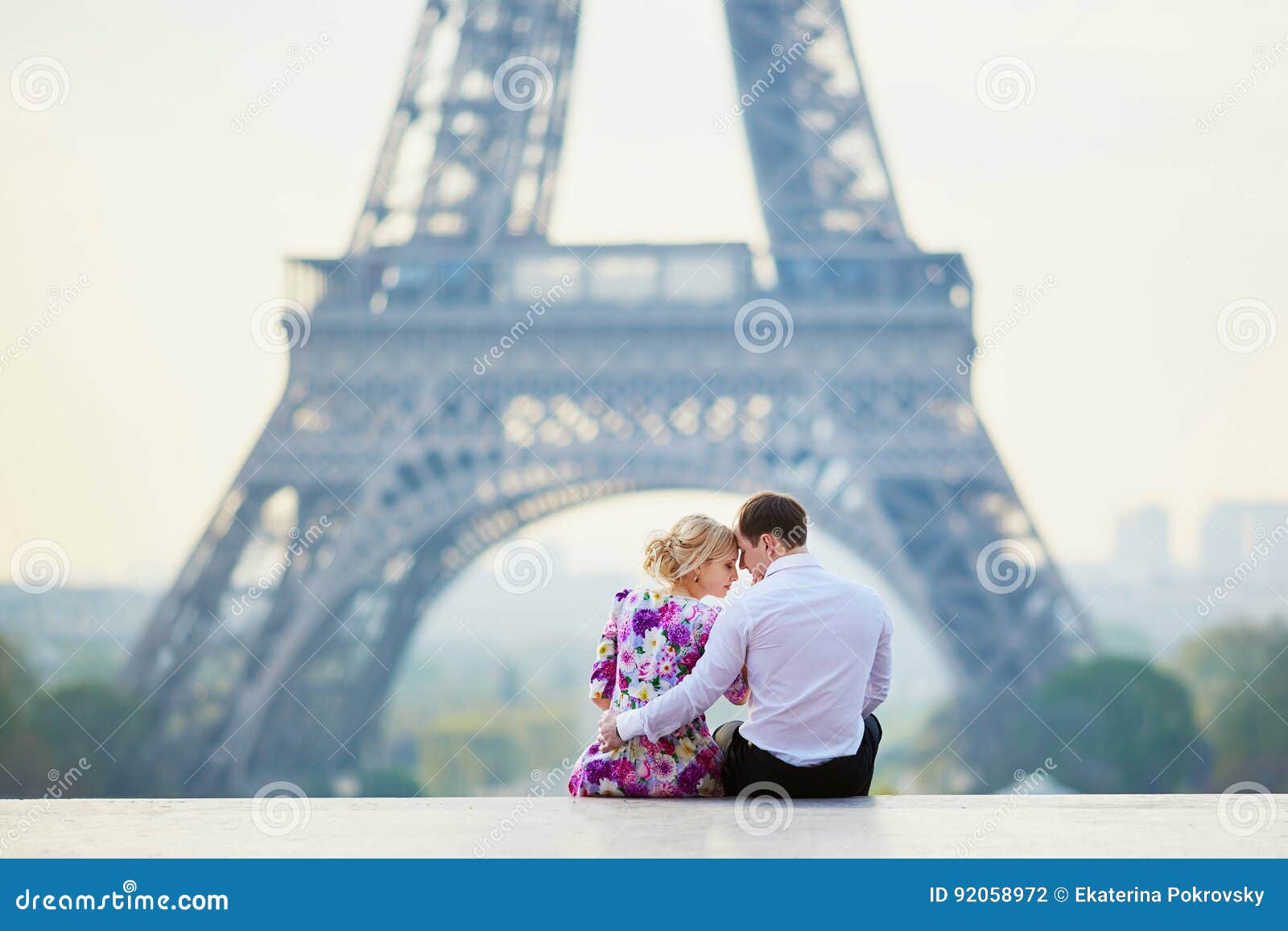 Romantic Couple Sitting Near The Eiffel Tower In Paris France Stock