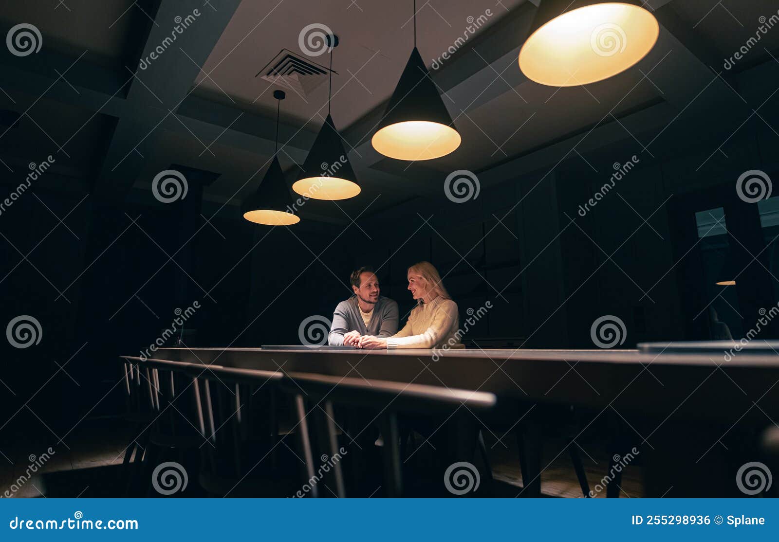 The Romantic Couple Sitting at the Table in Empty Night Restaurant ...