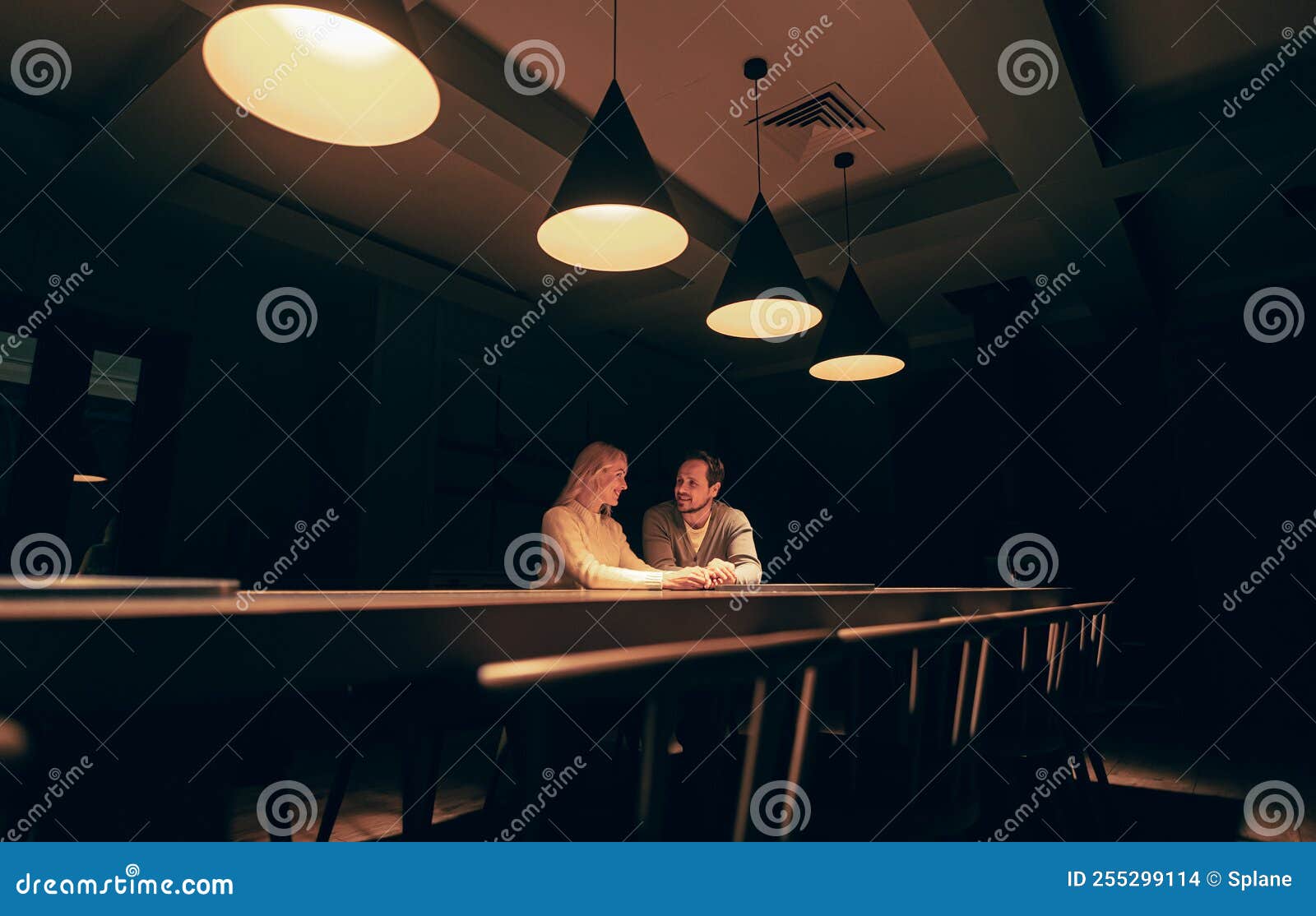 The Romantic Couple Sitting at the Table in Empty Night Restaurant ...