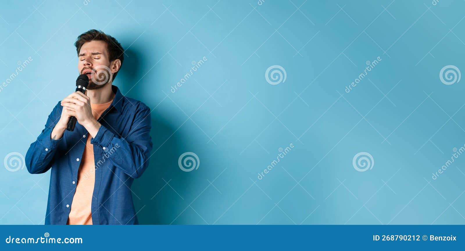 Romantic Guy Singing in Microphone, Performing on Stage, Standing on ...