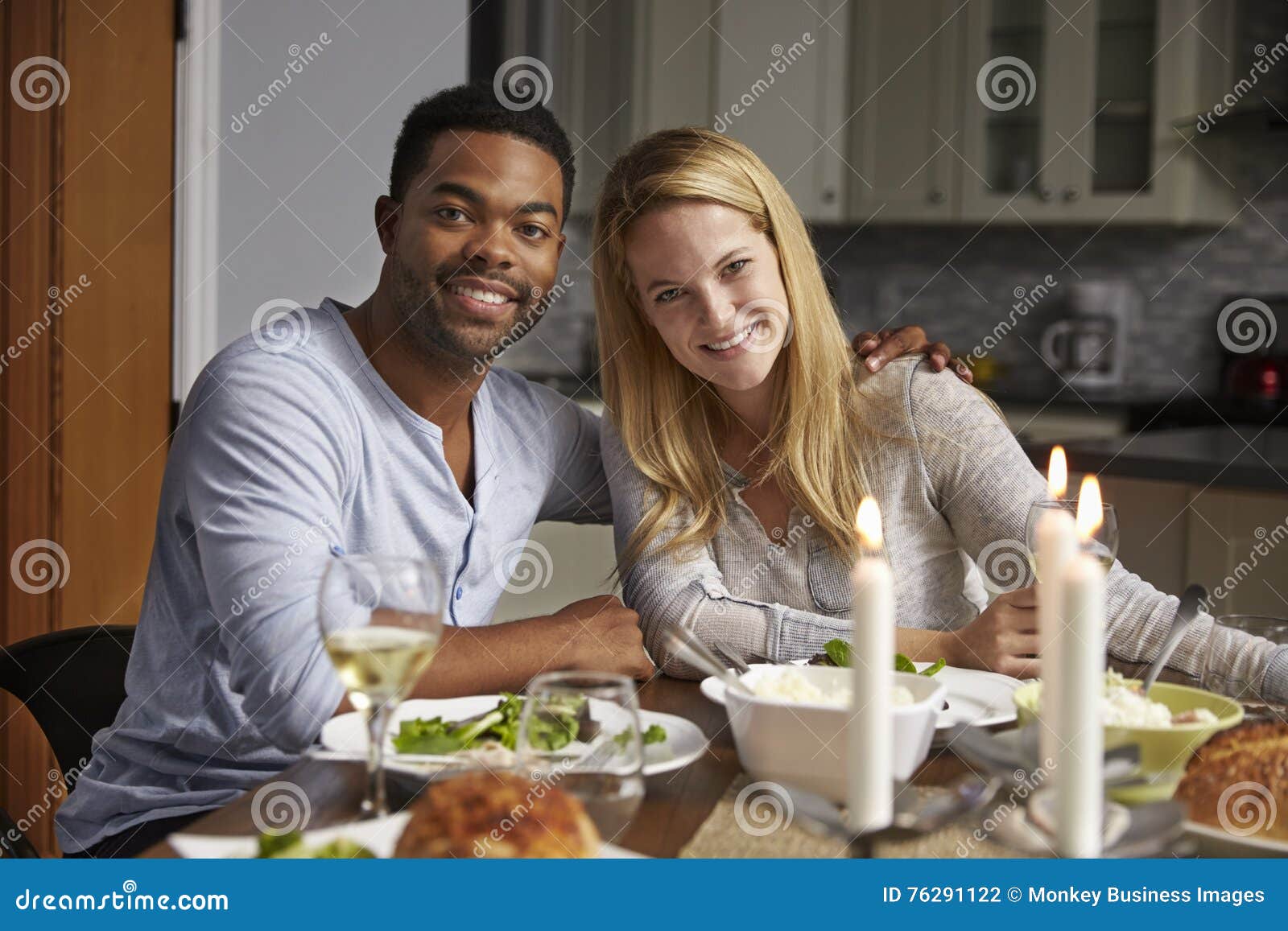 Romantic Mixed Race Couple Look To Camera at Meal in Kitchen Stock ...