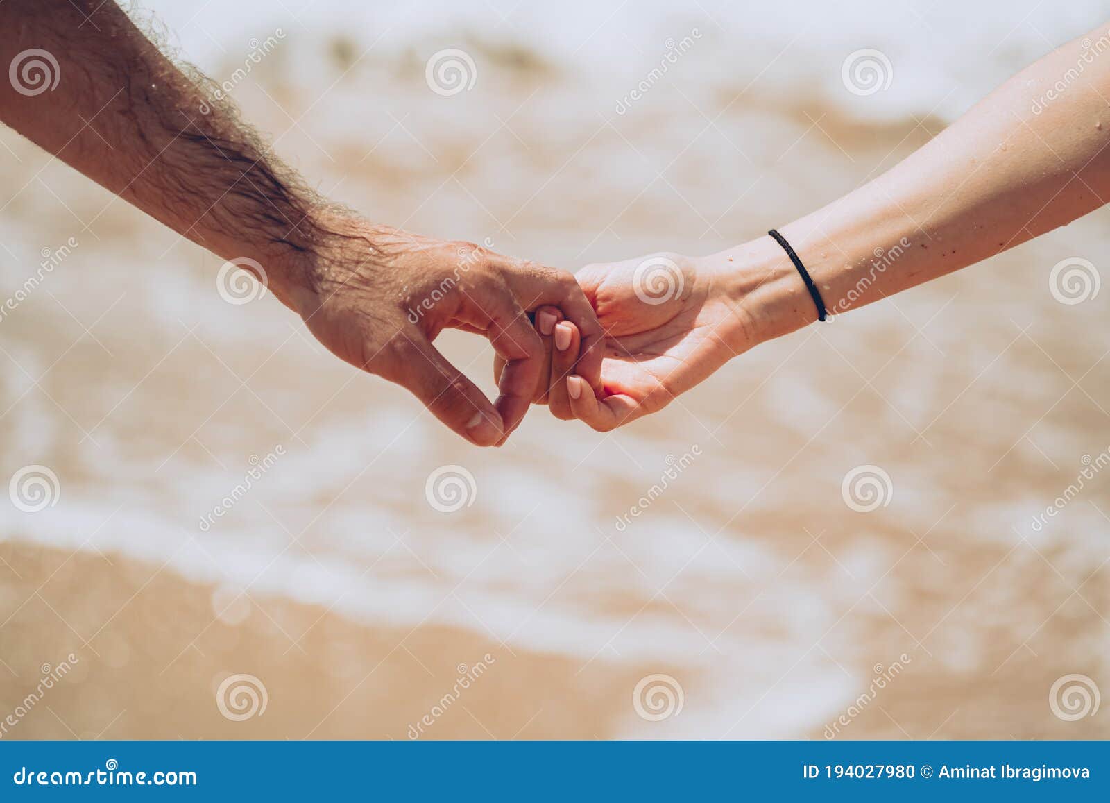 Romantic Touching Hands of a Couple in Love on the Sea Beach Stock ...