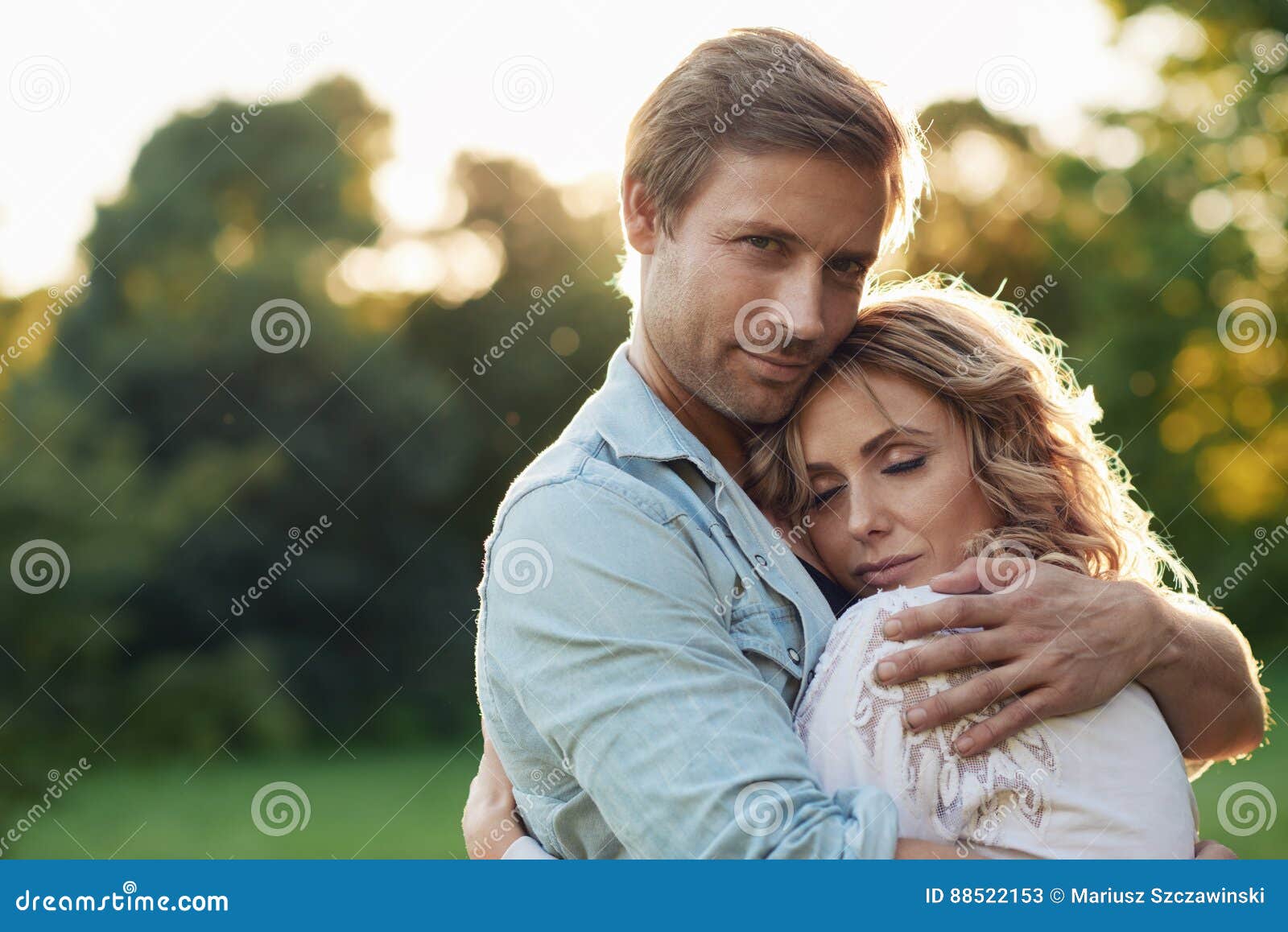 Romantic Young Couple Embracing Each Other At Sunset Stock Image