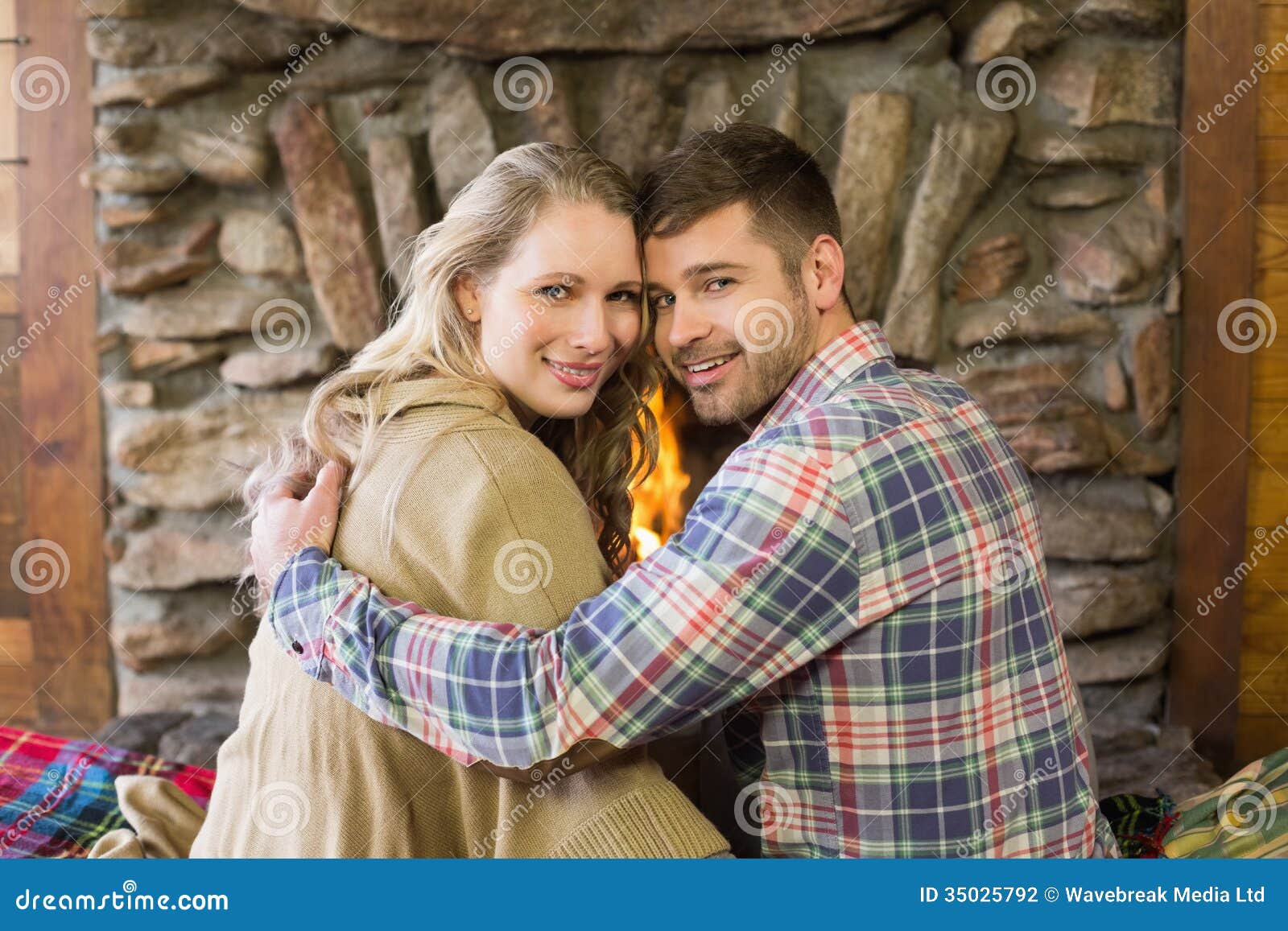 Romantic Young Couple in Front of Lit Fireplace Stock Photo - Image of ...