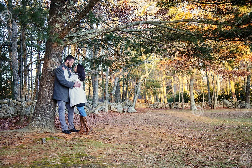 Romantic Young Couple Hugging Under a Tree on a Cold Fall Day Stock ...