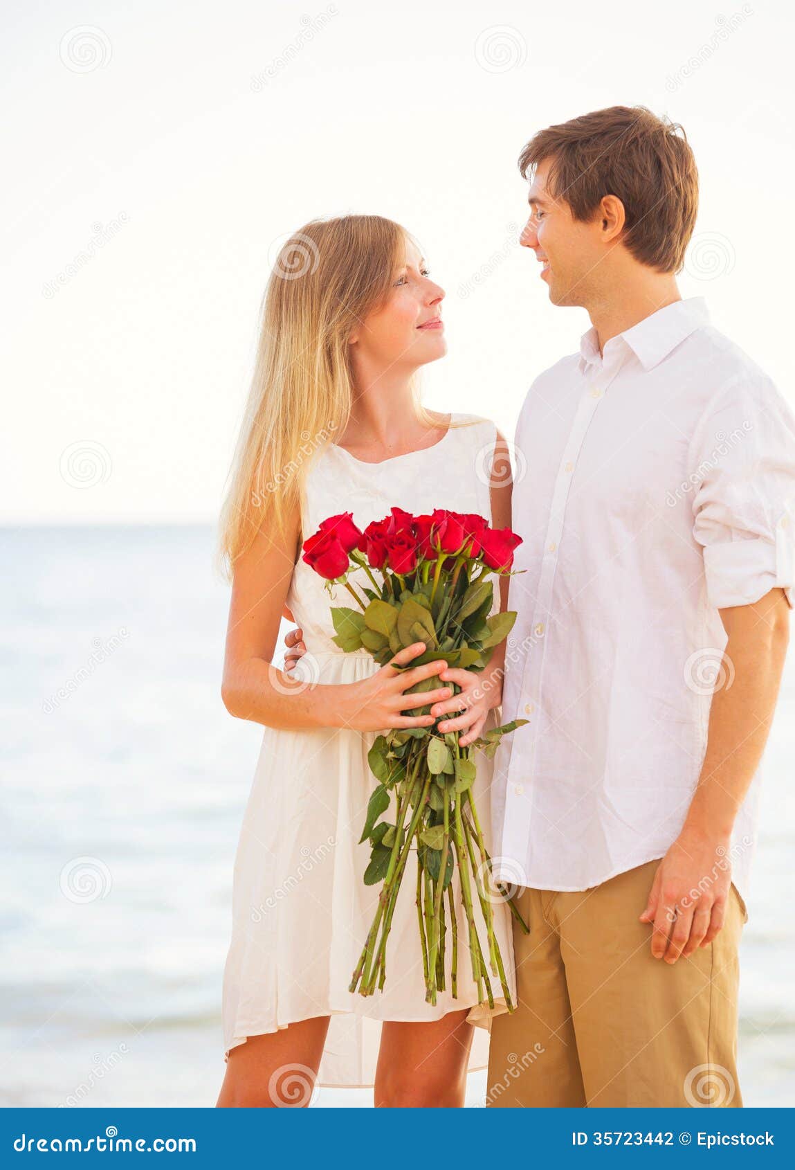 Romantic Young Couple In Love Man Holding Surprise Bouquet Of R Stock