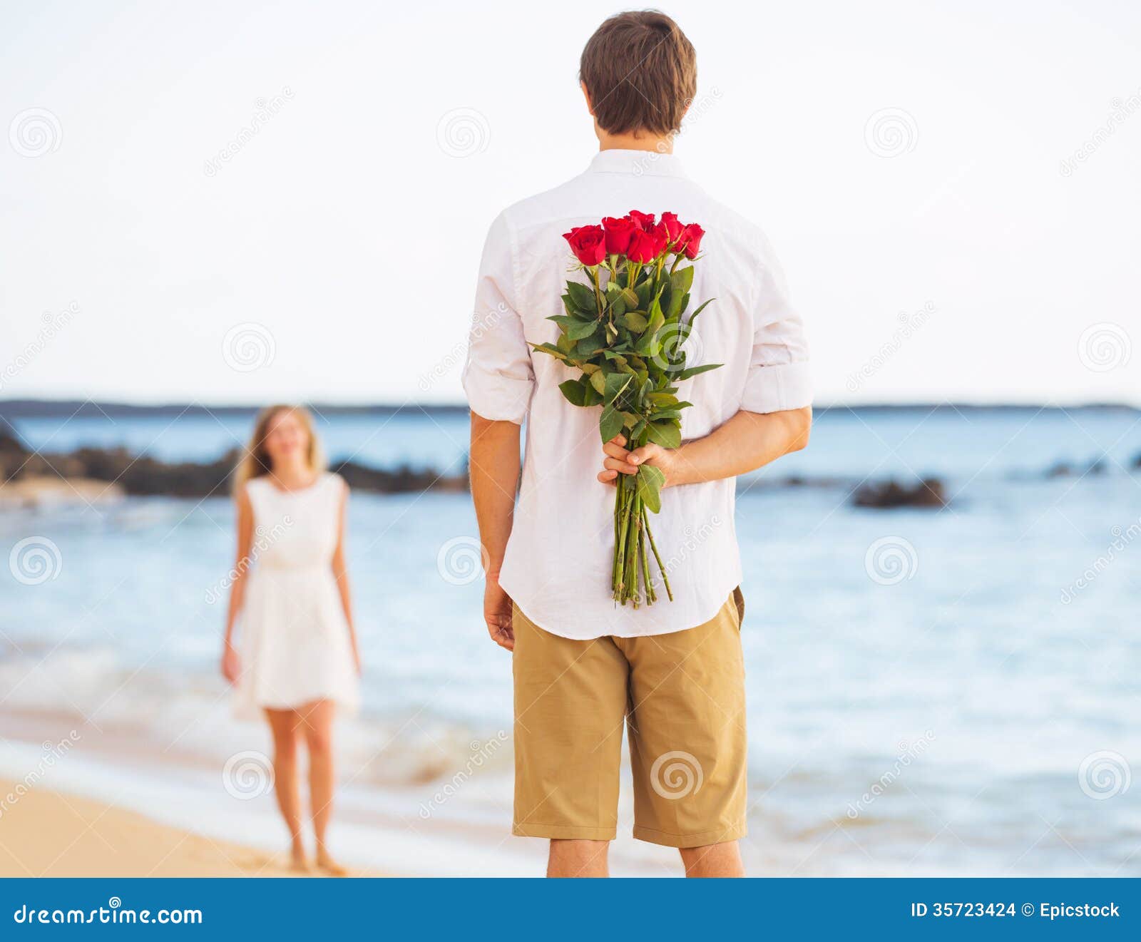 Romantic Young Couple In Love Man Holding Surprise Bouquet Of R Stock