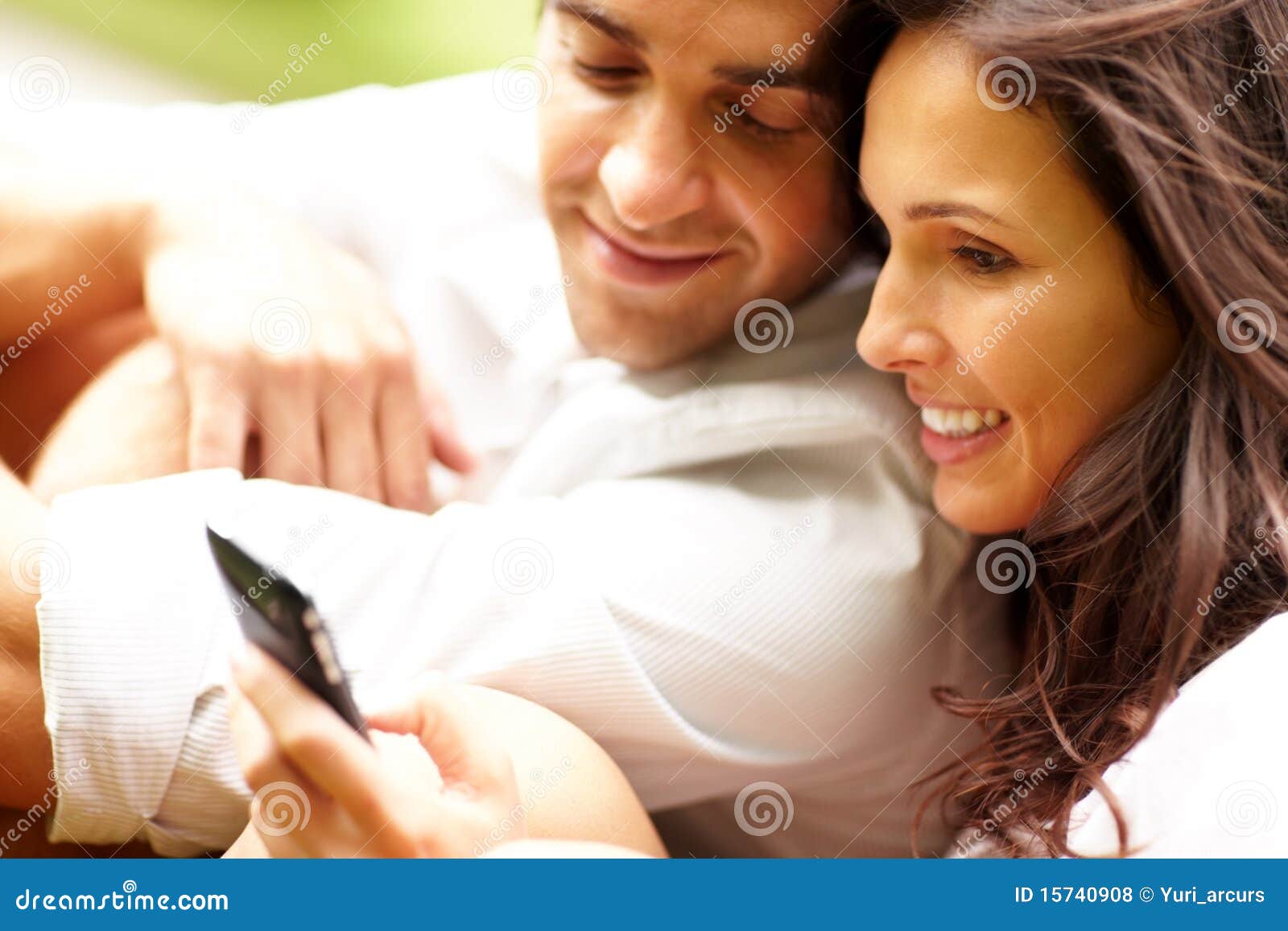 Romantic Young Couple Using a Mobile Phone Stock Photo - Image of ...