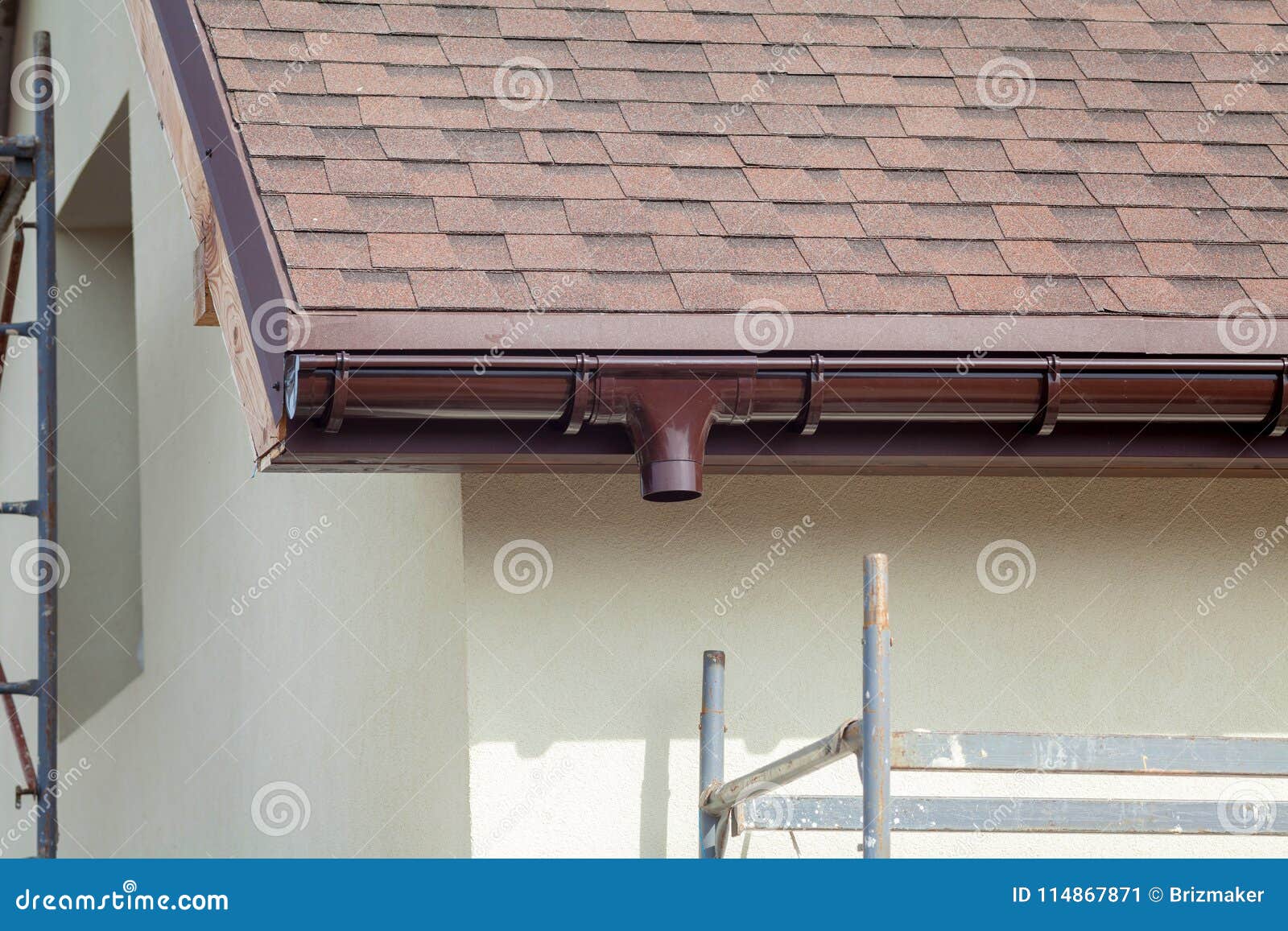 Roof Under Construction with New Asphalt Tile and Rain Gutter. Stock ...