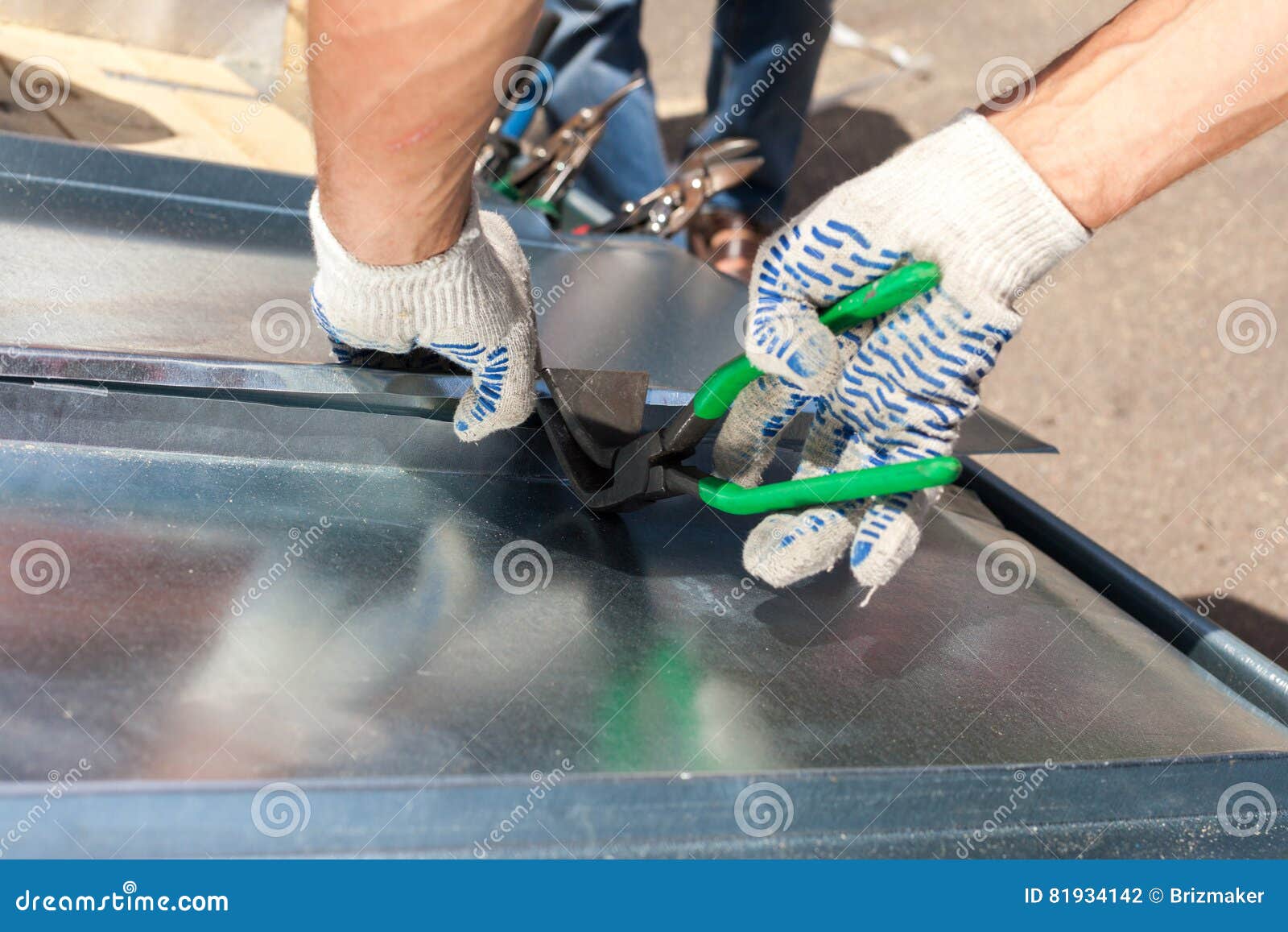 Roofer Folding a Metal Sheet Using Special Pliers with a Large Flat ...