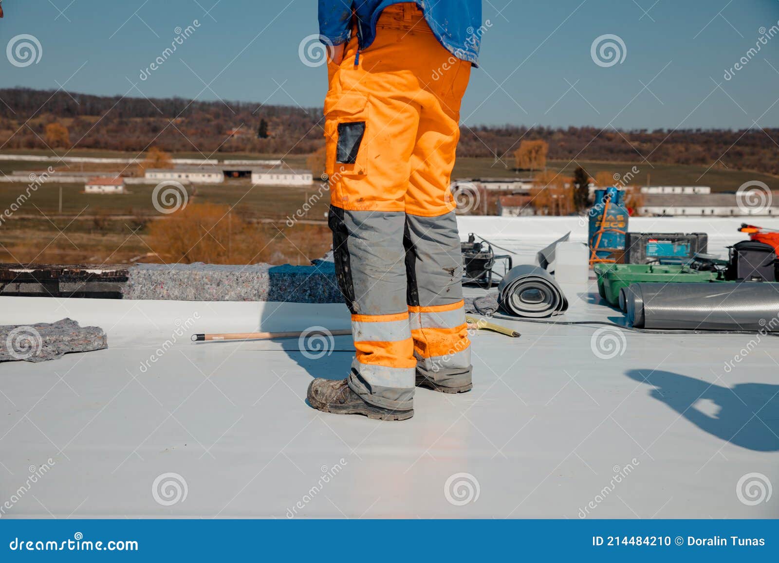 Roofer Man Works on a Flat Roof with Pvc Membrane Insulation System ...