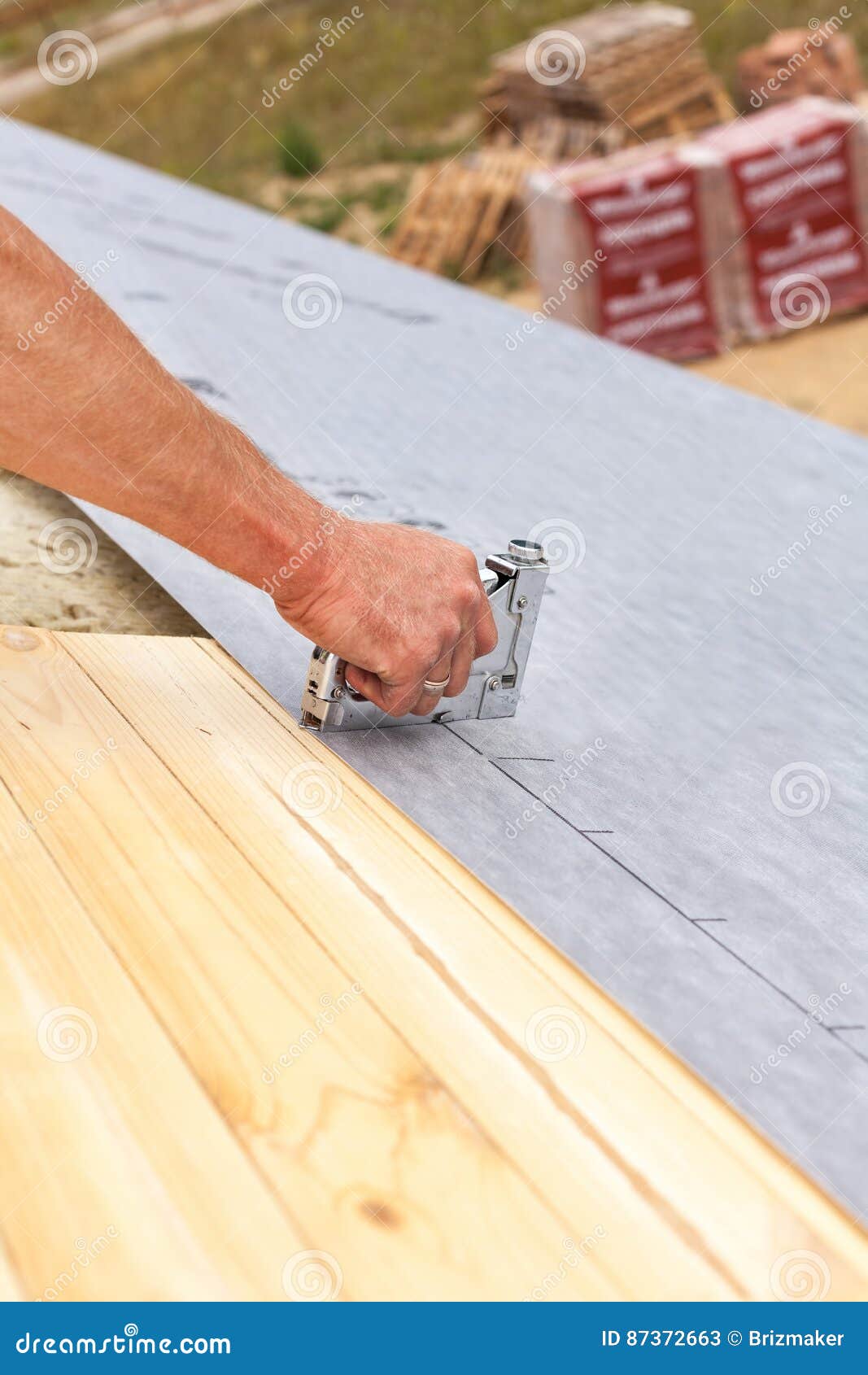 Roofer Nails Lining Using Construction Stapler. Roof Under Construction ...