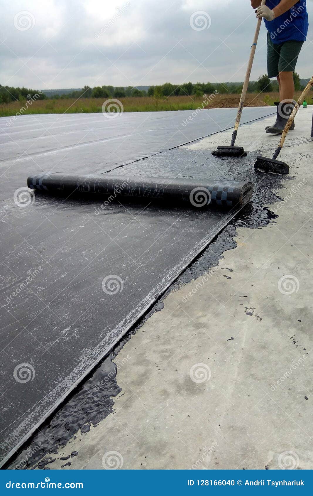 Roofer Worker Painting Bitumen Praimer at Concrete Surface by the ...