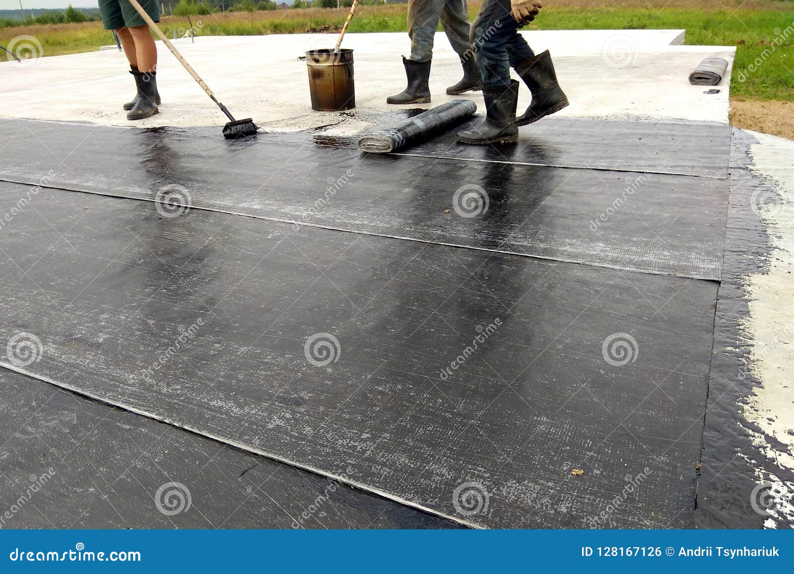 Roofer Worker Painting Bitumen Praimer at Concrete Surface by the ...