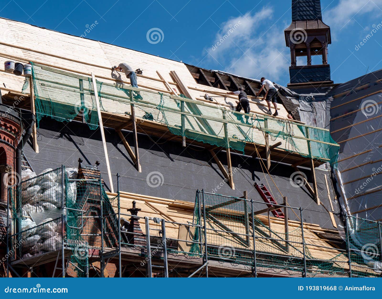 Roofers at work on a roof stock photo. Image of work - 193819668