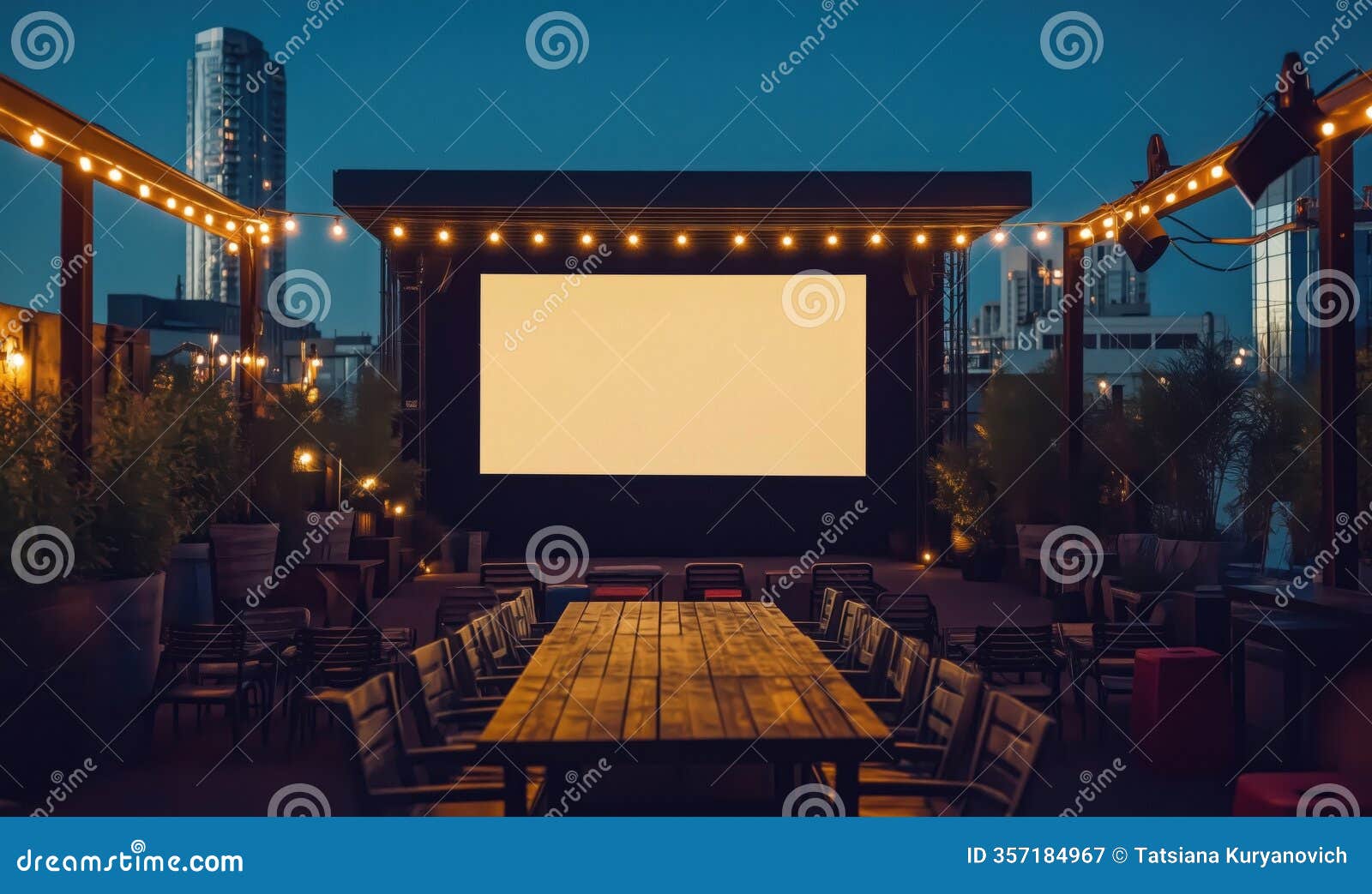 Rooftop Cinema Setup with Large Screen, Tables, and String Lights Stock ...