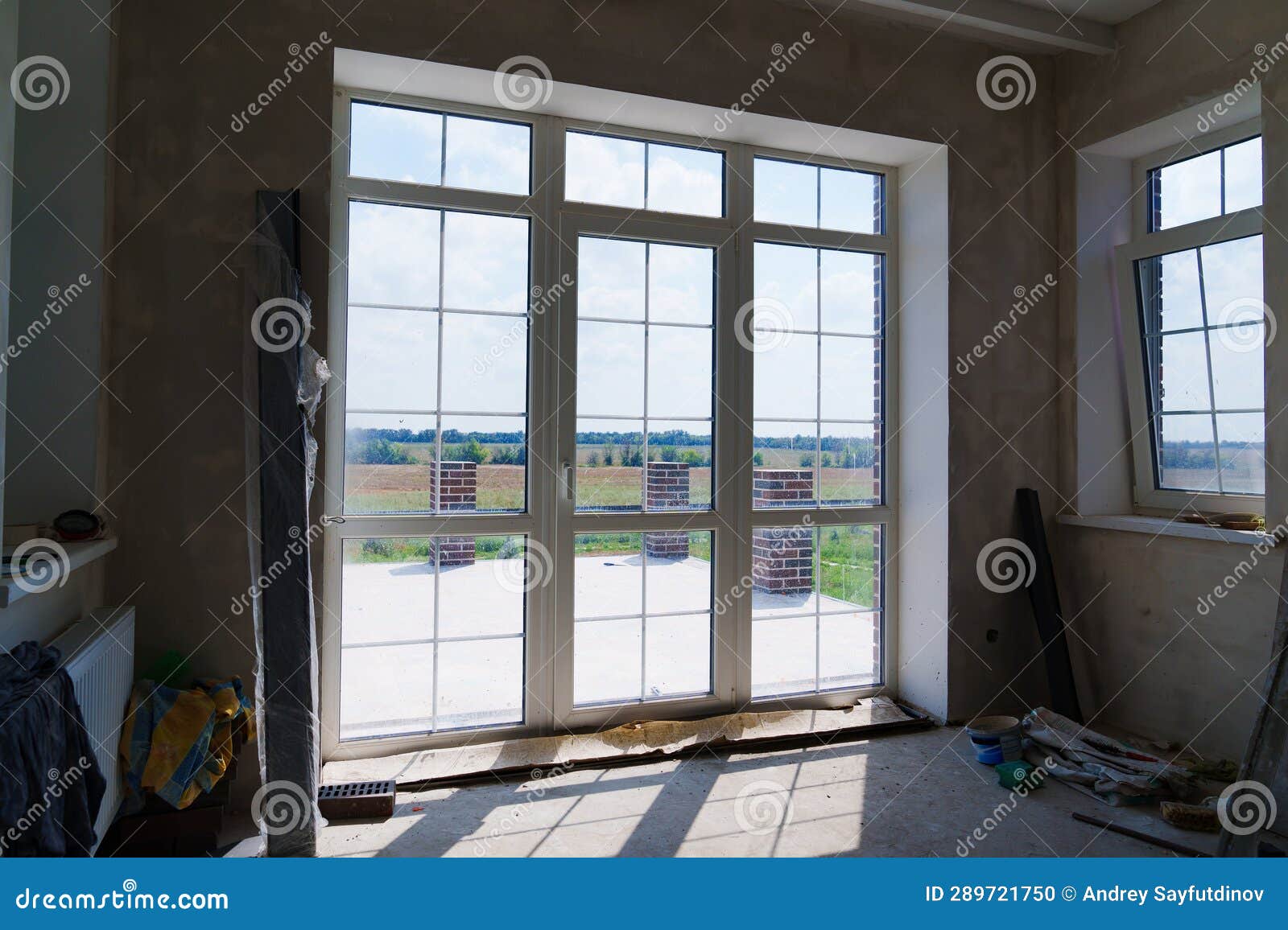 A Room with a Large Window in a House Under Construction. Stock Photo ...