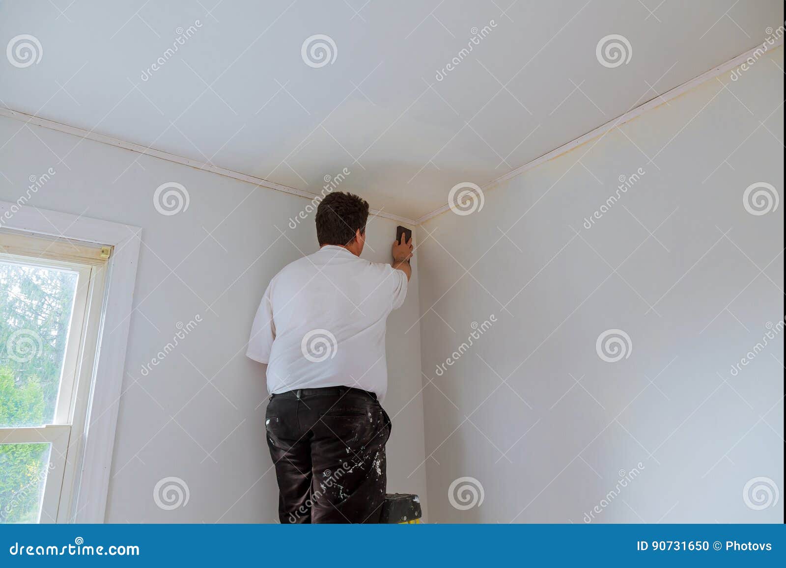 Room Repair, Hand Sanding the Wall with a Sanding Sponge Stock Photo ...