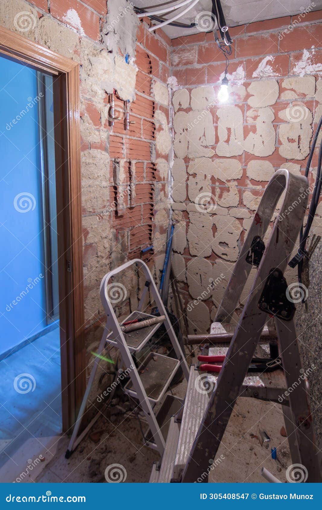 A Room Under Renovation with Chipped Walls, Debris on the Floor ...
