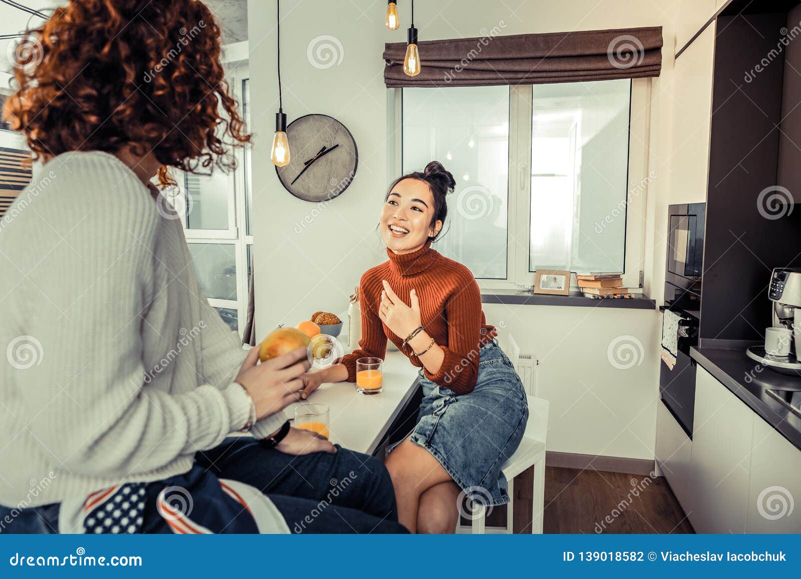 Roommates Feeling Involved in Conversation in the Kitchen Stock Photo ...