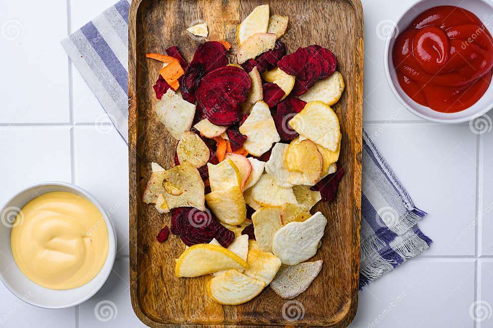 Root Vegetable Crisps, on White Ceramic Squared Tile Table Background ...