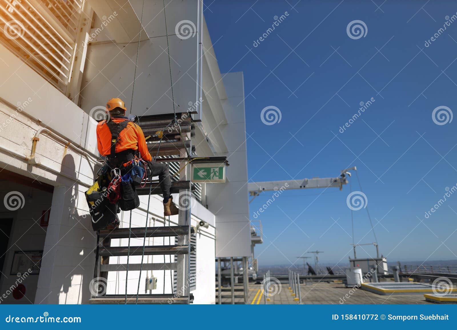 Rope Access Abseiler Working at Height Installing Exit Sign at Roof Top ...