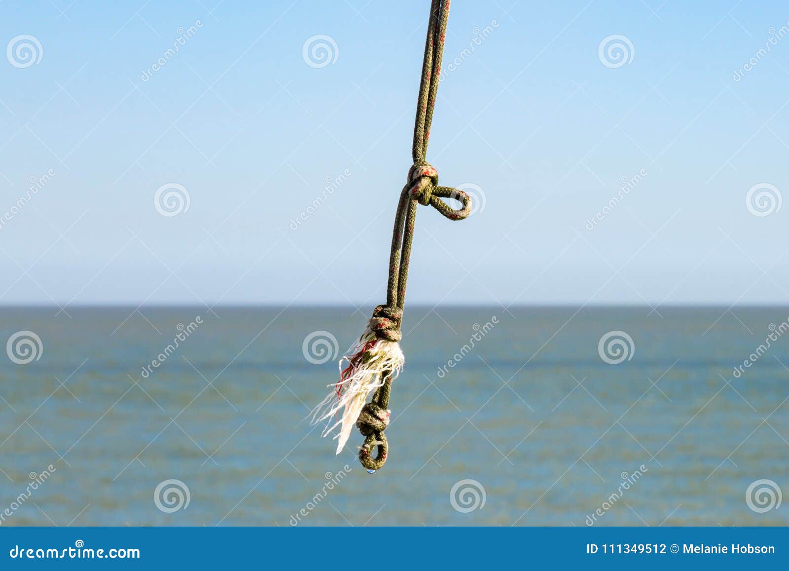 A Rope Dangling in Front of the Sea Stock Photo - Image of blurry ...