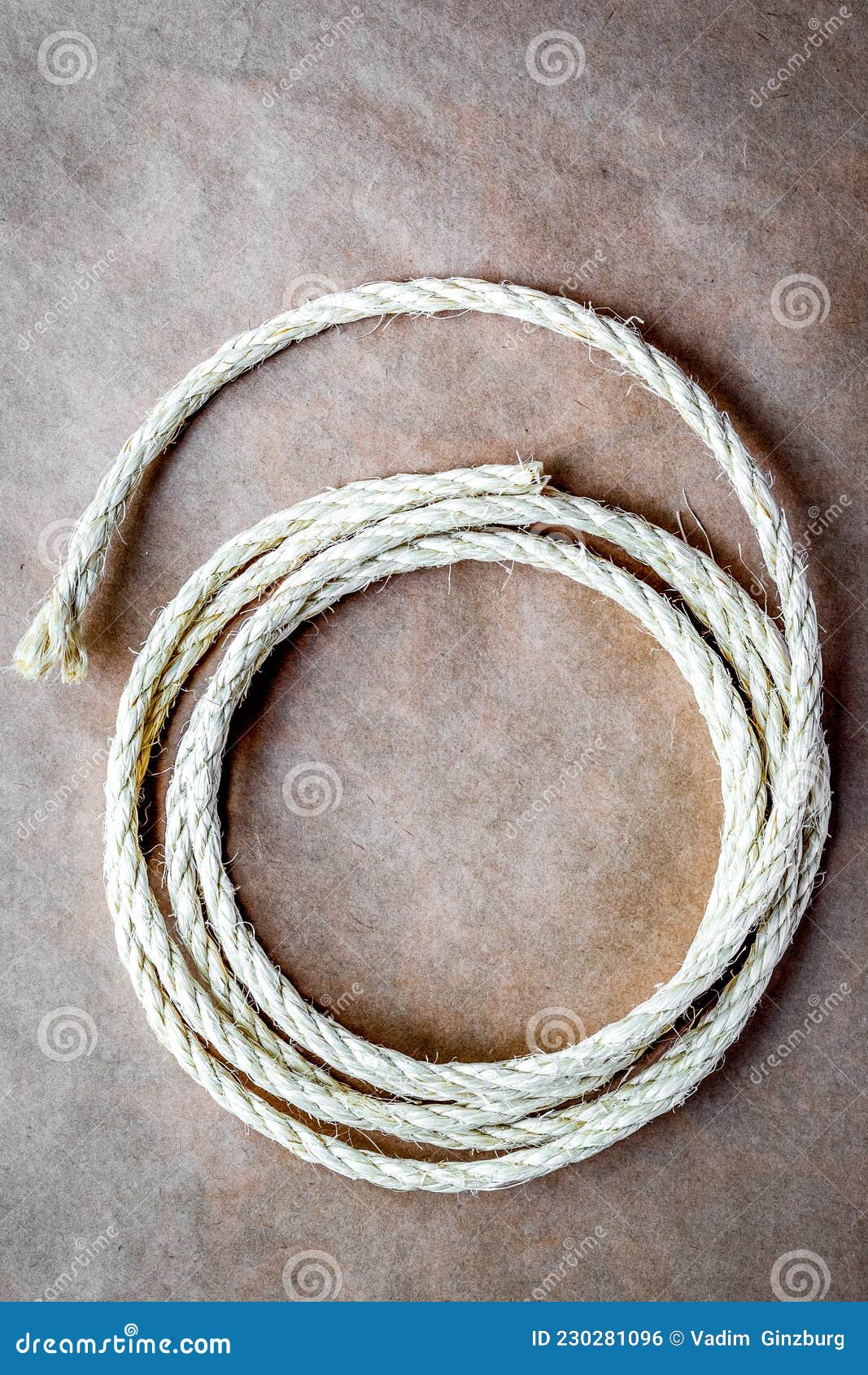 Rope Coiled at Kraft Paper on the Background Stock Photo - Image of ...