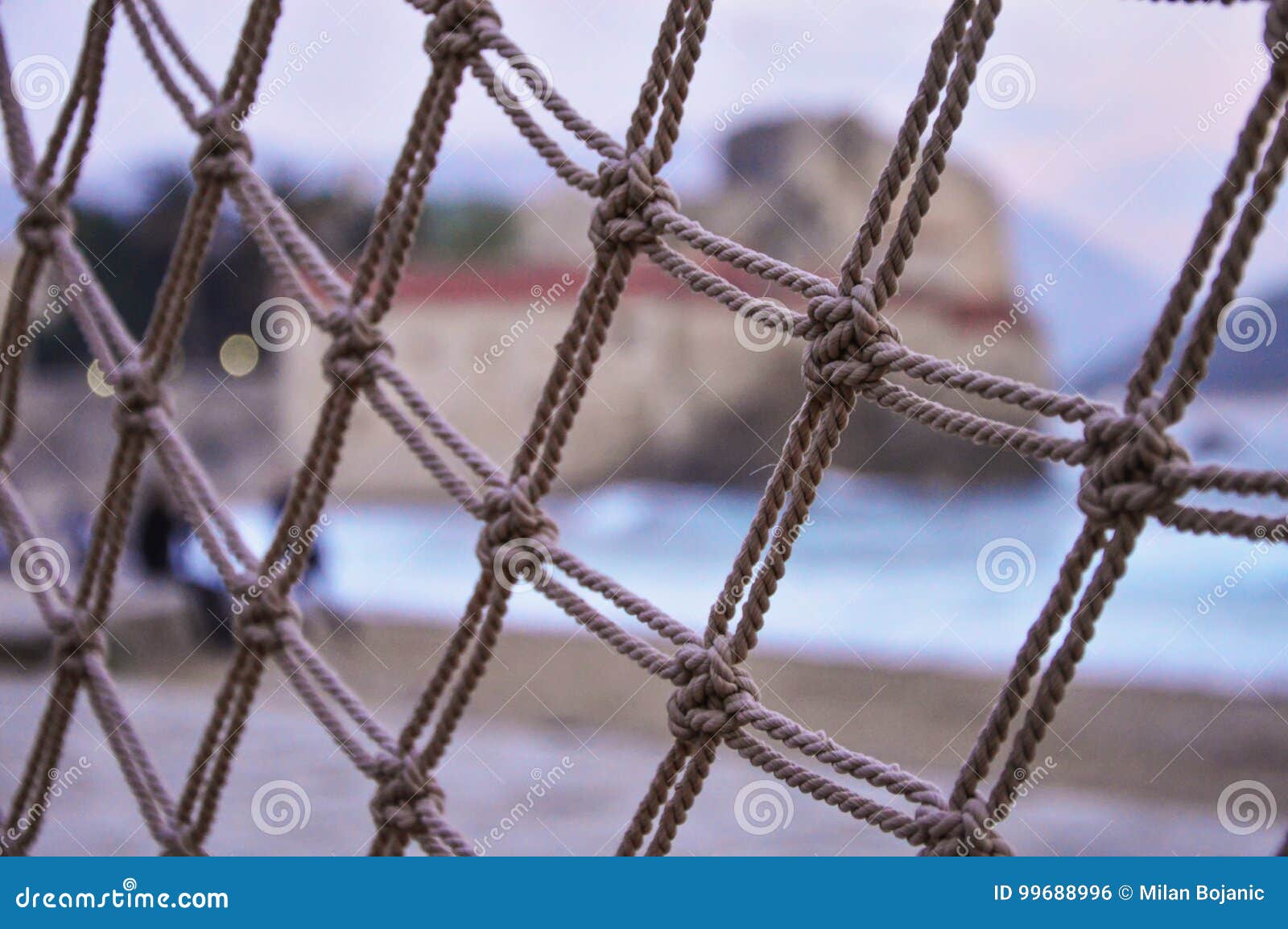 Rope Net Pattern with a Beach and Old Town in the Background Stock ...