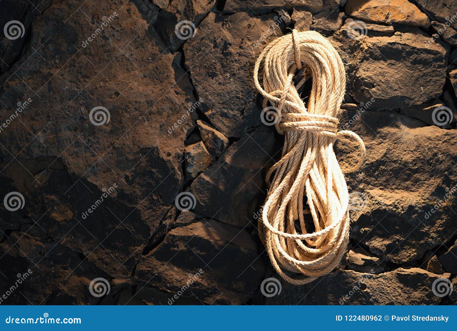 Rope on a stone wall stock photo. Image of folded, roll - 122480962