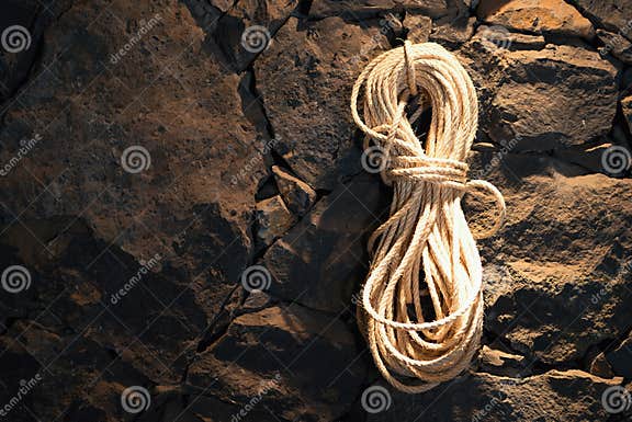 Rope on a stone wall stock photo. Image of folded, roll - 122480962