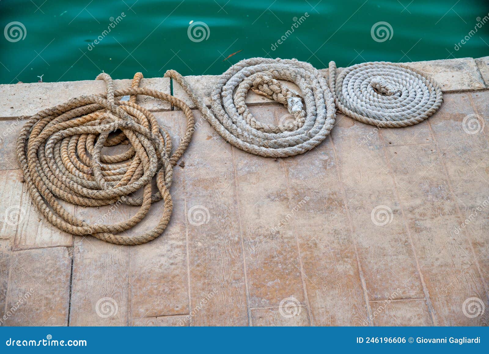 Ropes Rolled Up Along the Pier Stock Photo - Image of white, sailing ...