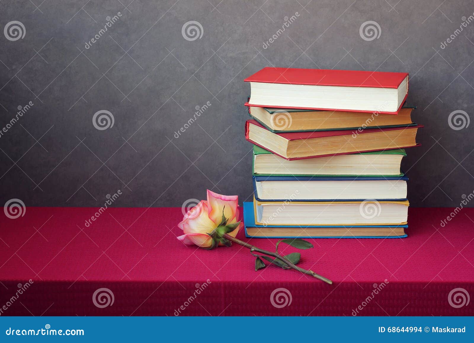 Rose and the Pile of Books on the Table with a Red Tablecloth. Stock ...