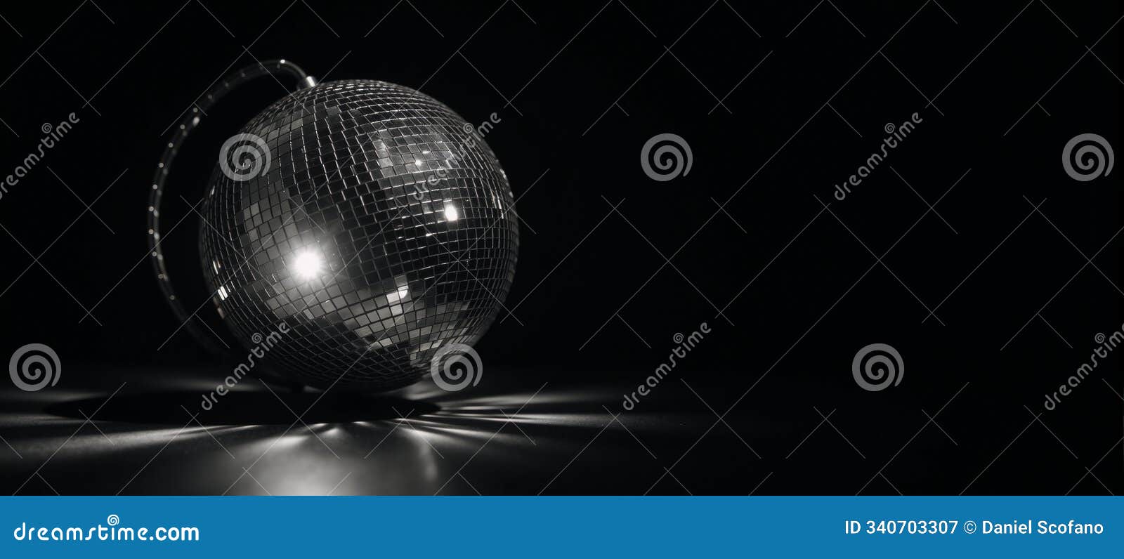 A Rotating Blackandwhite Disco Ball Glows Against Dark Background ...