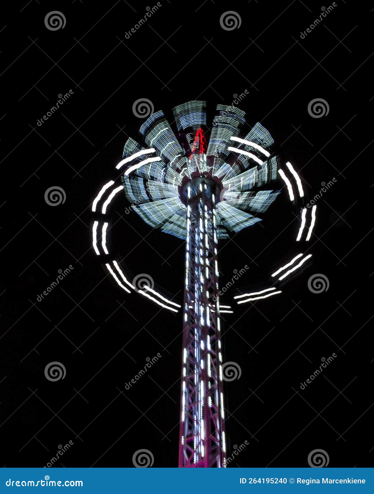 Rotating Illuminated Attraction in Amusement Park at Night. Stock Photo ...