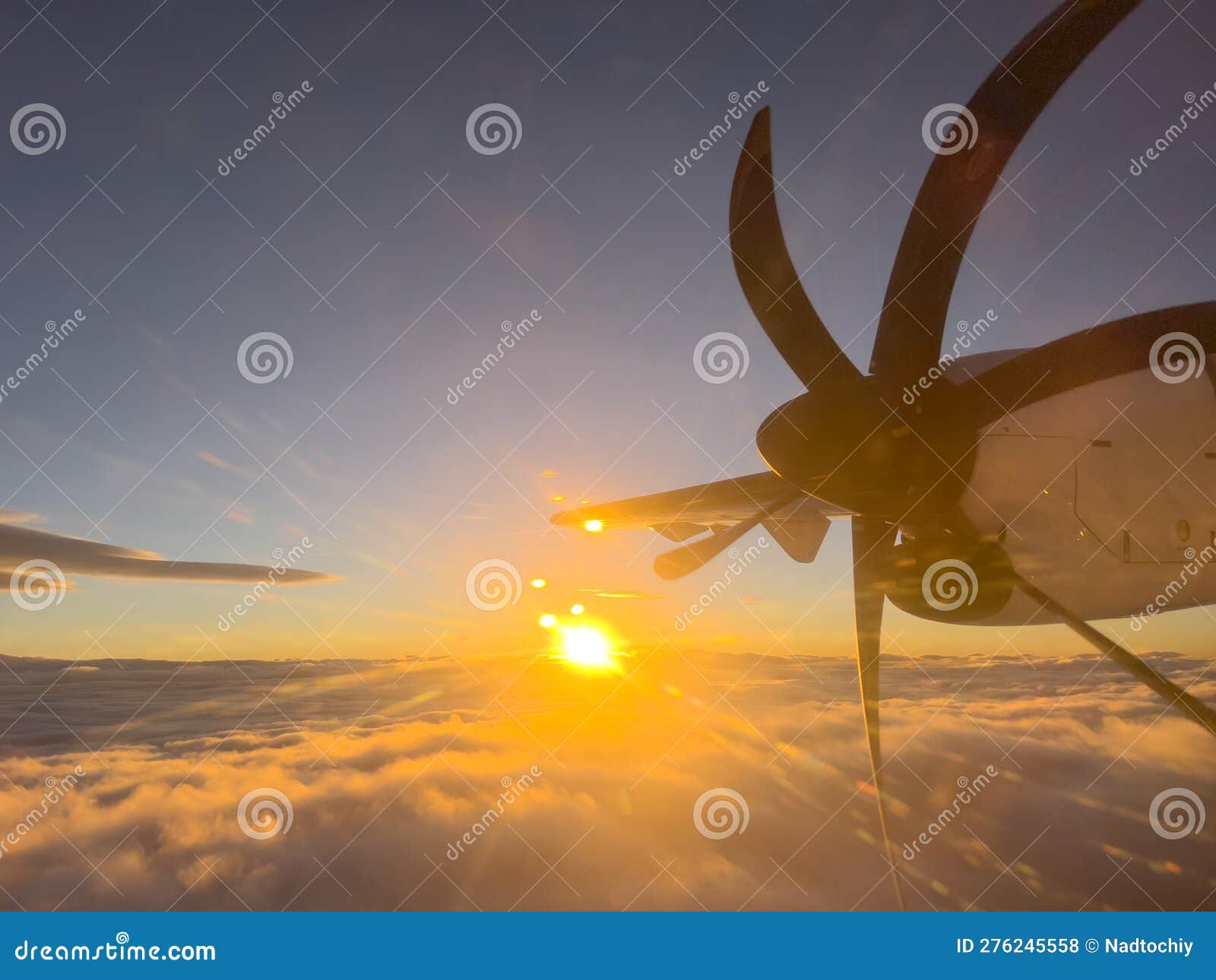 Rotating Propeller of an Airplane Flying in the Rays of the Setting Sun ...