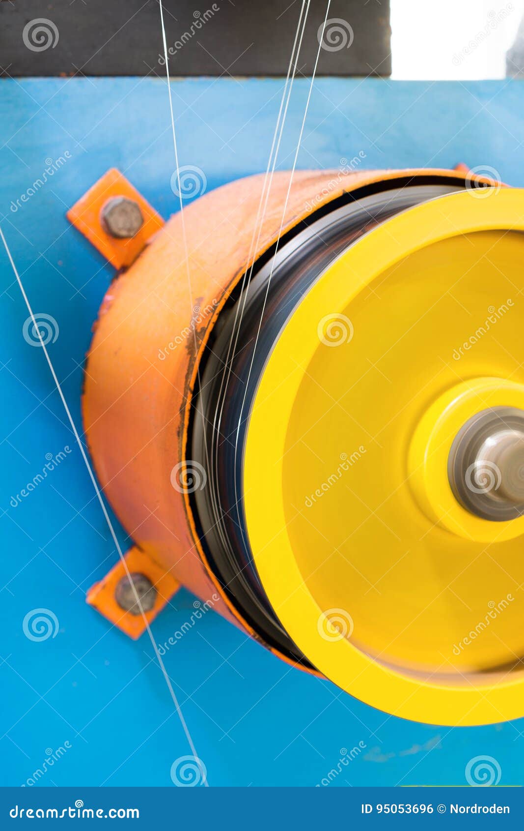 A Rotating Wheel Rewinds a Thin Silver Wire. Stock Photo - Image of ...