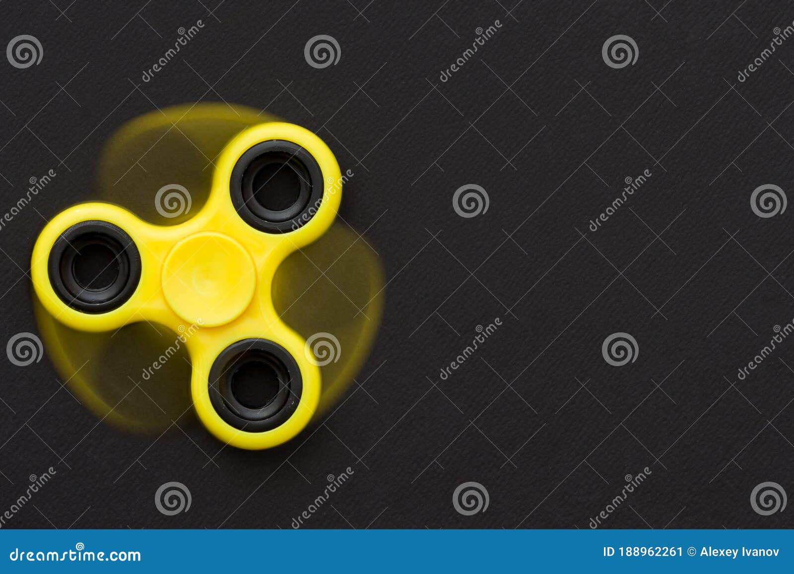 Rotating Yellow Fidget Spinner Device On Black Background. Top View ...