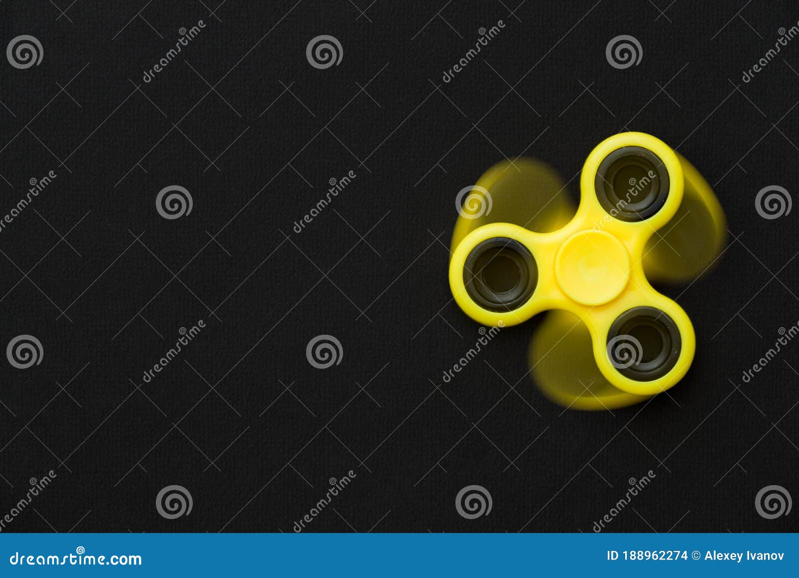 Rotating Yellow Fidget Spinner Device On Black Background. Top View ...