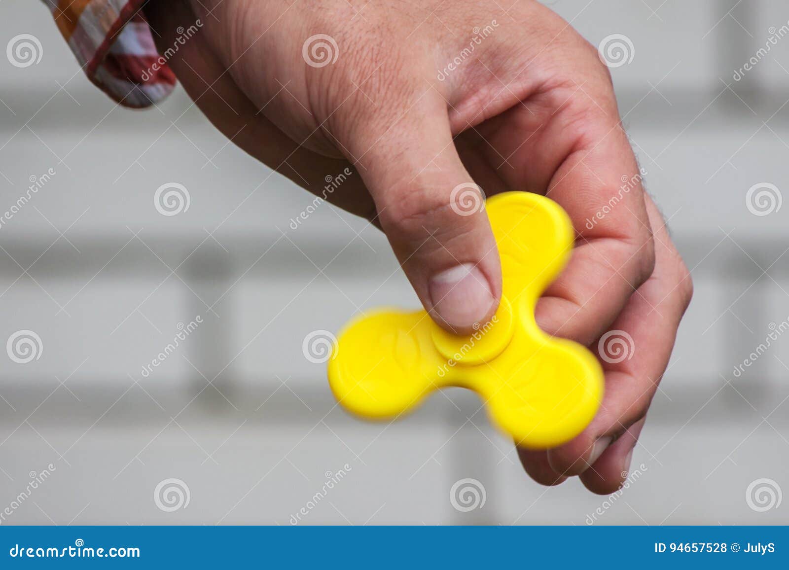 Rotating Yellow Fidget Spinner Device On Black Background. Top View ...