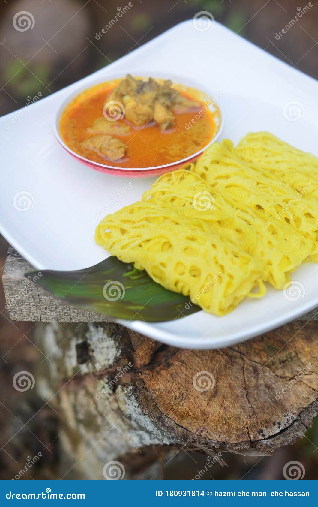 Roti Jala or Net Bread with Chicken Curry Gravy Sauce on Blurred ...