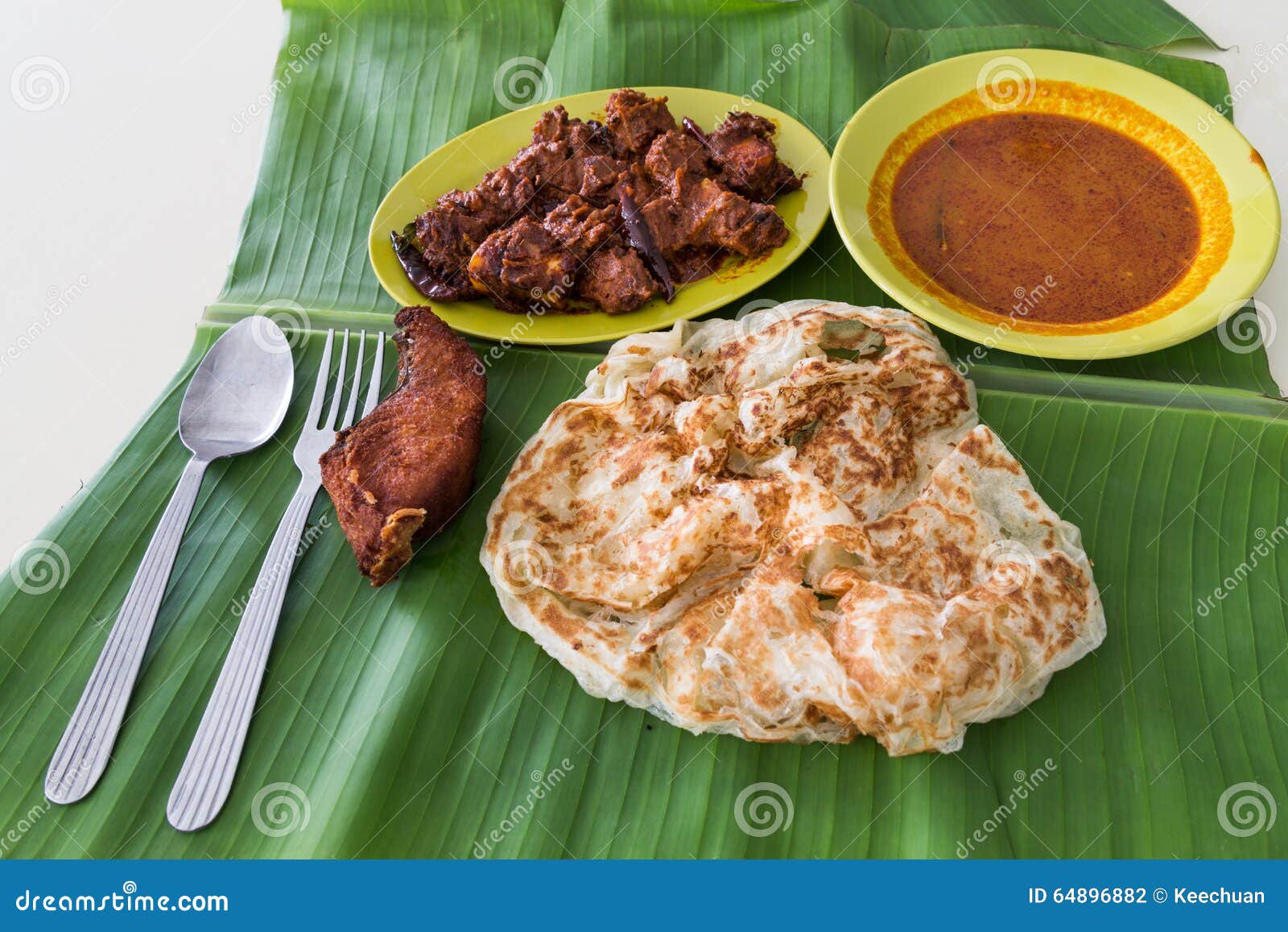 Roti Prata on Banana Leaf with Masala Mutton, Fish, Curry Stock Photo ...