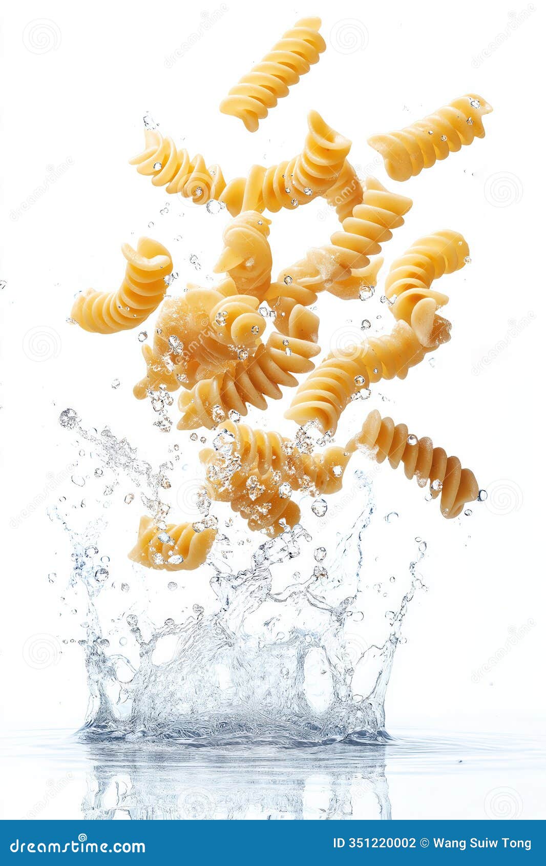 Rotini Pasta Splashing Into Water On White Background Stock Photo ...